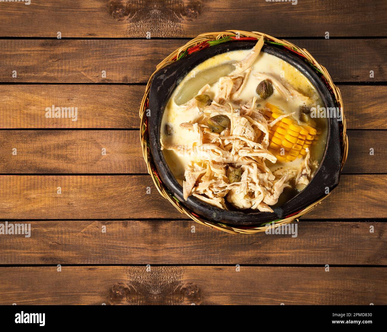 Ajiaco, traditional Colombian food, accompanied by shredded chicken ...