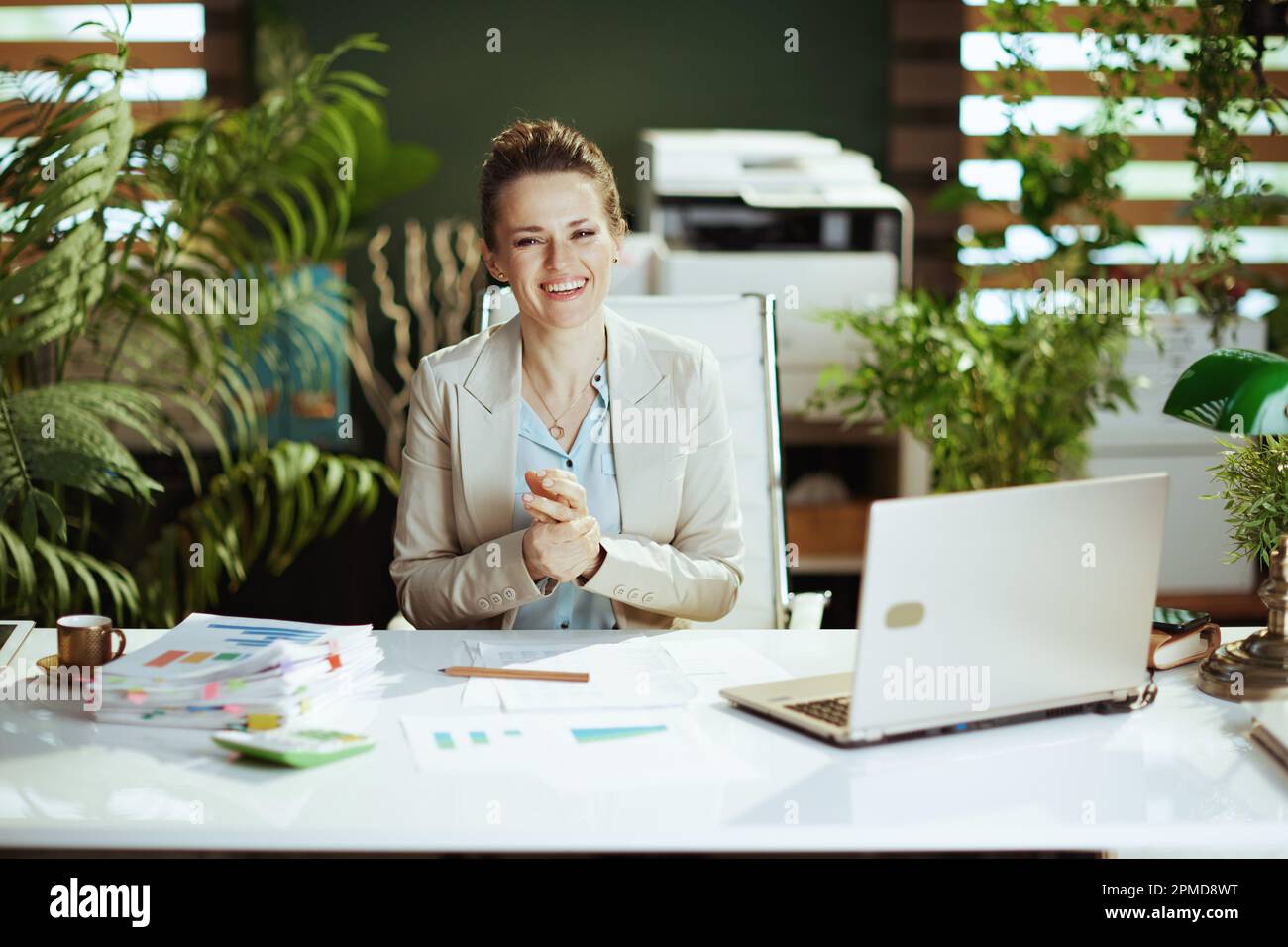 Portrait of smiling modern middle aged bookkeeper woman in a light ...