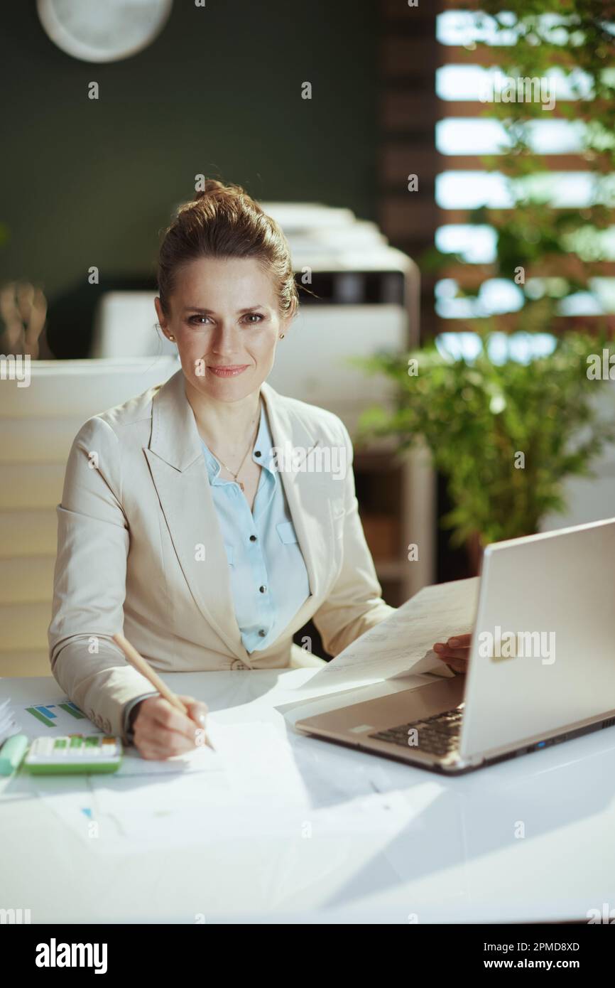 Portrait of modern bookkeeper woman in a light business suit in modern ...
