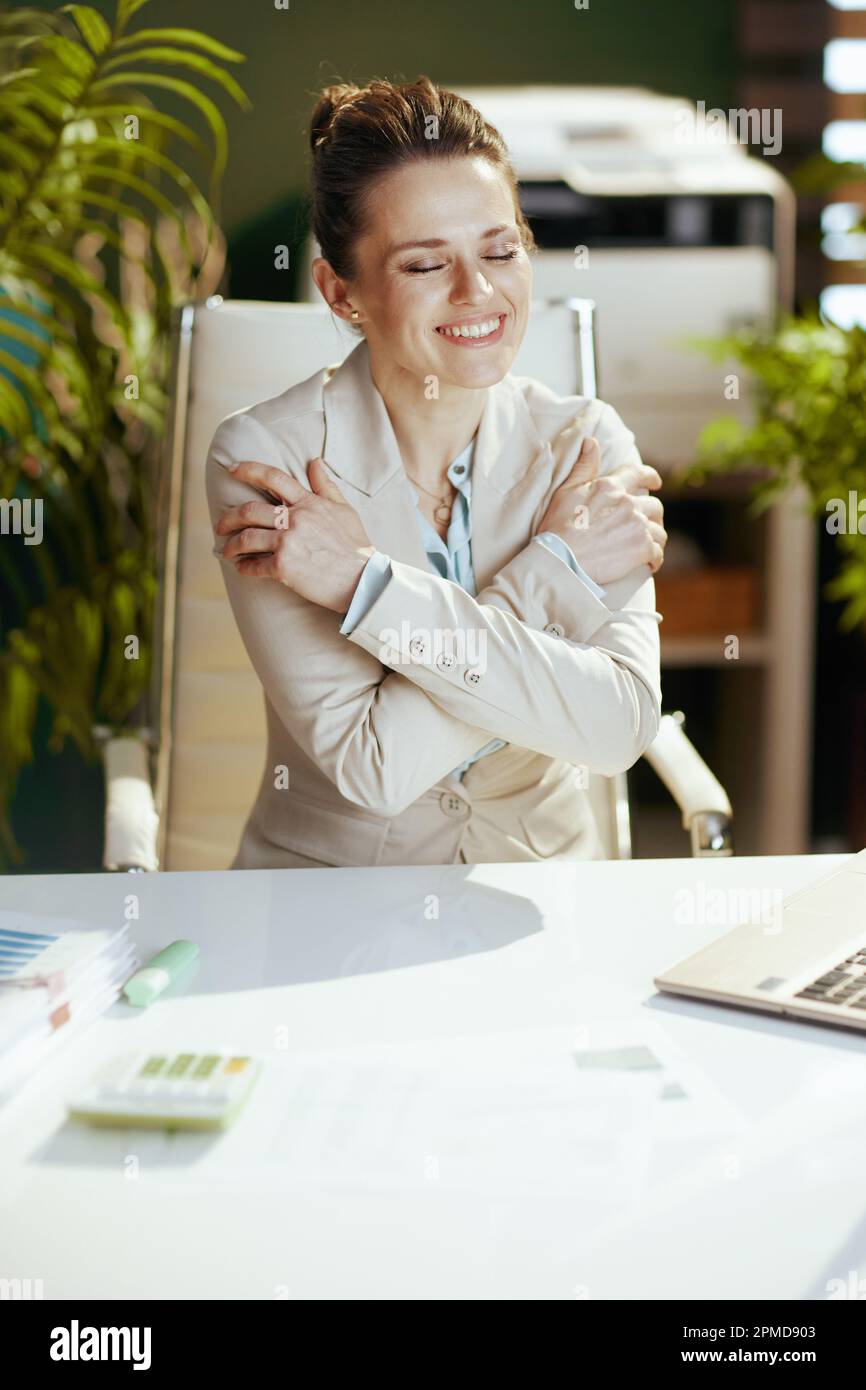 smiling modern 40 years old bookkeeper woman in a light business suit ...