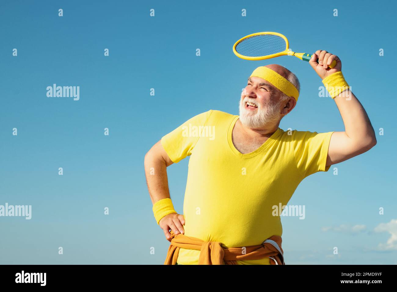 Elderly man playing Badminton. Portrait of healthy senior sport man ...