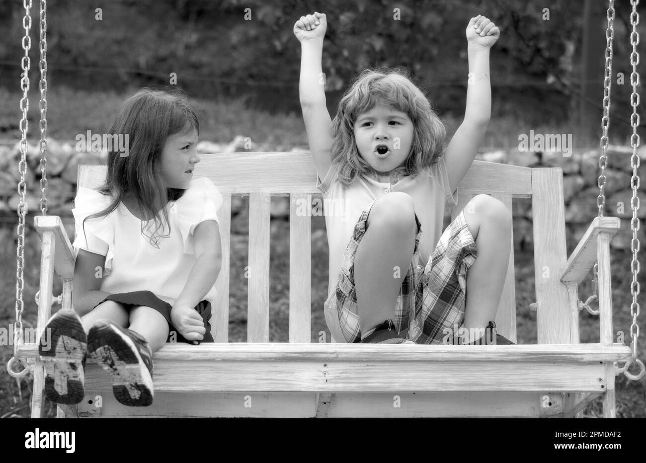 Brother and sister playing outside. Little excited amazed boy and girl ...