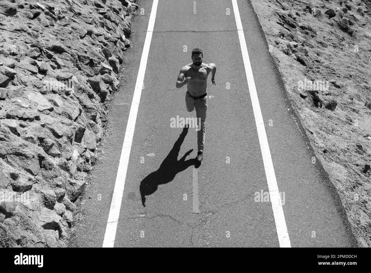 Full length of healthy man running and jogging outdoors. Male runner ...