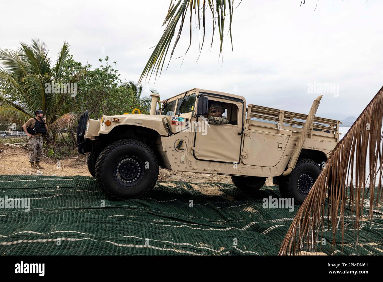A U.S. Marine with 3rd Landing Support Battalion, drives a Navy Humvee ...