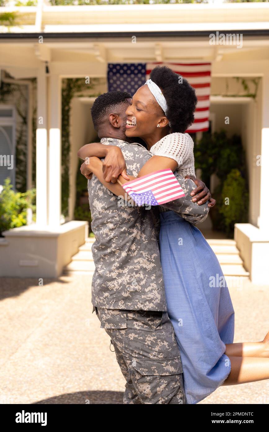 African american soldier husband embracing excited wife after returning ...