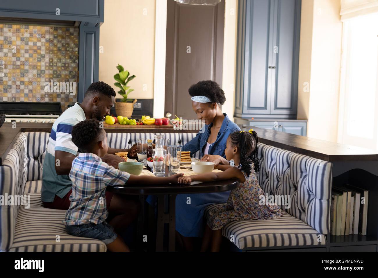 African american parents and children having fresh breakfast at dining ...