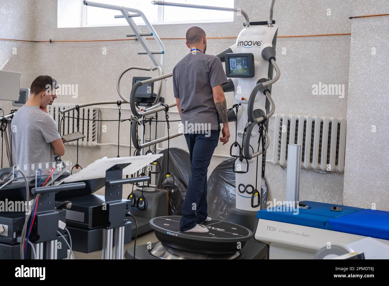 A man works on equipment for physical rehabilitation. An international ...