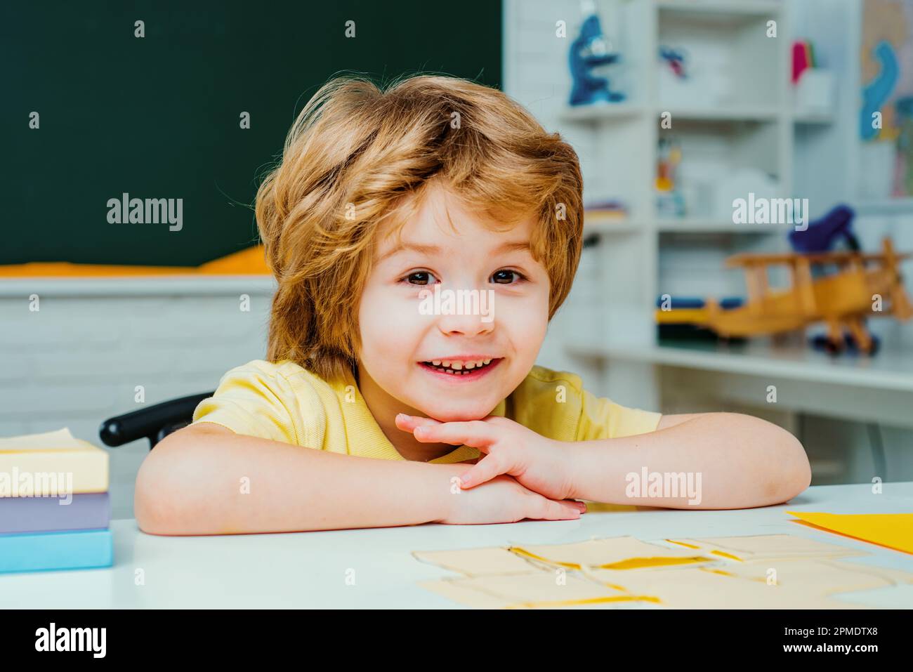 Cute little preschool kid boy with teacher study in a classroom Stock ...