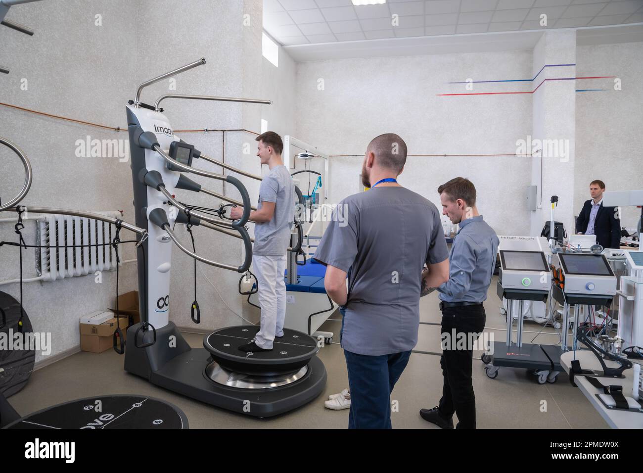 A man works on physical rehabilitation equipment in the presence of ...