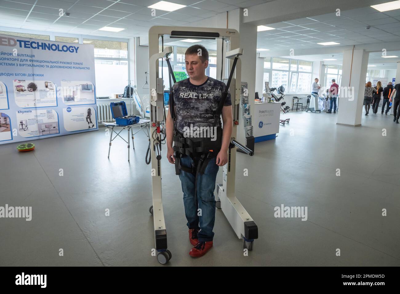 A man works on equipment for physical rehabilitation. An international ...