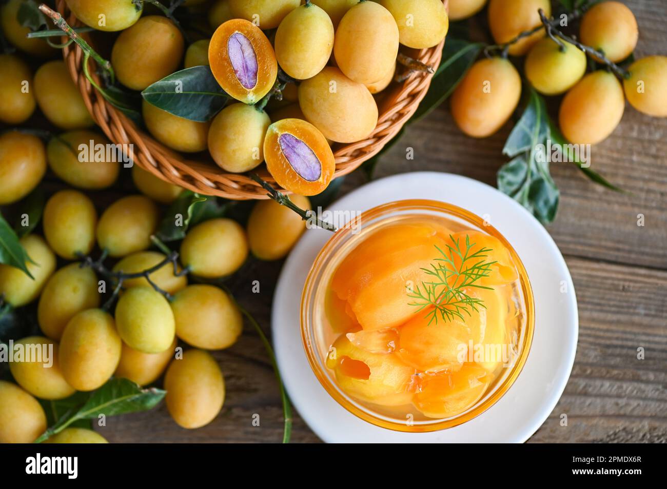 Sweet dessert marian plum fruit on bowl for food and wooden background ...