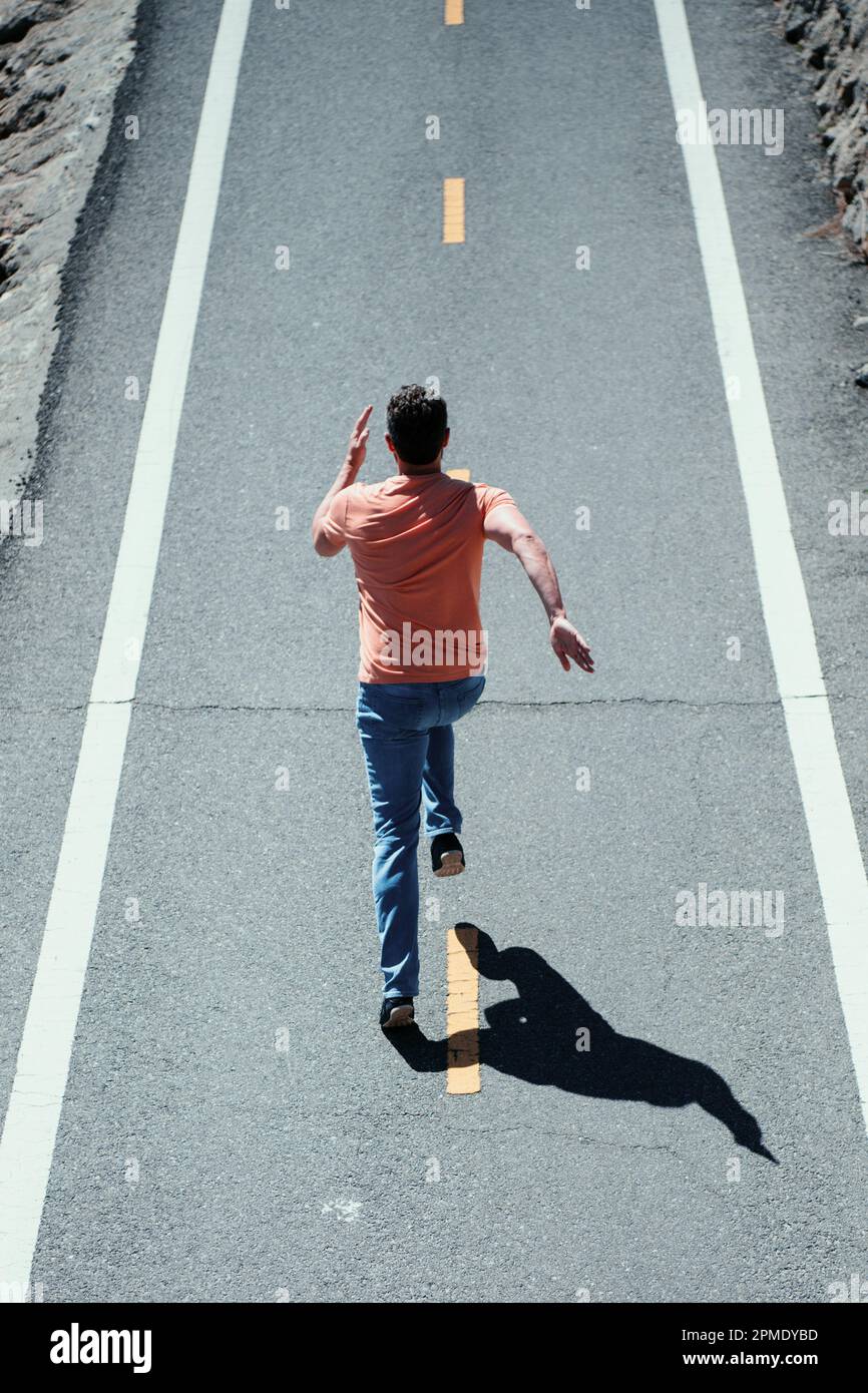 Back view of man runner running at road. Workout urban concept Stock ...