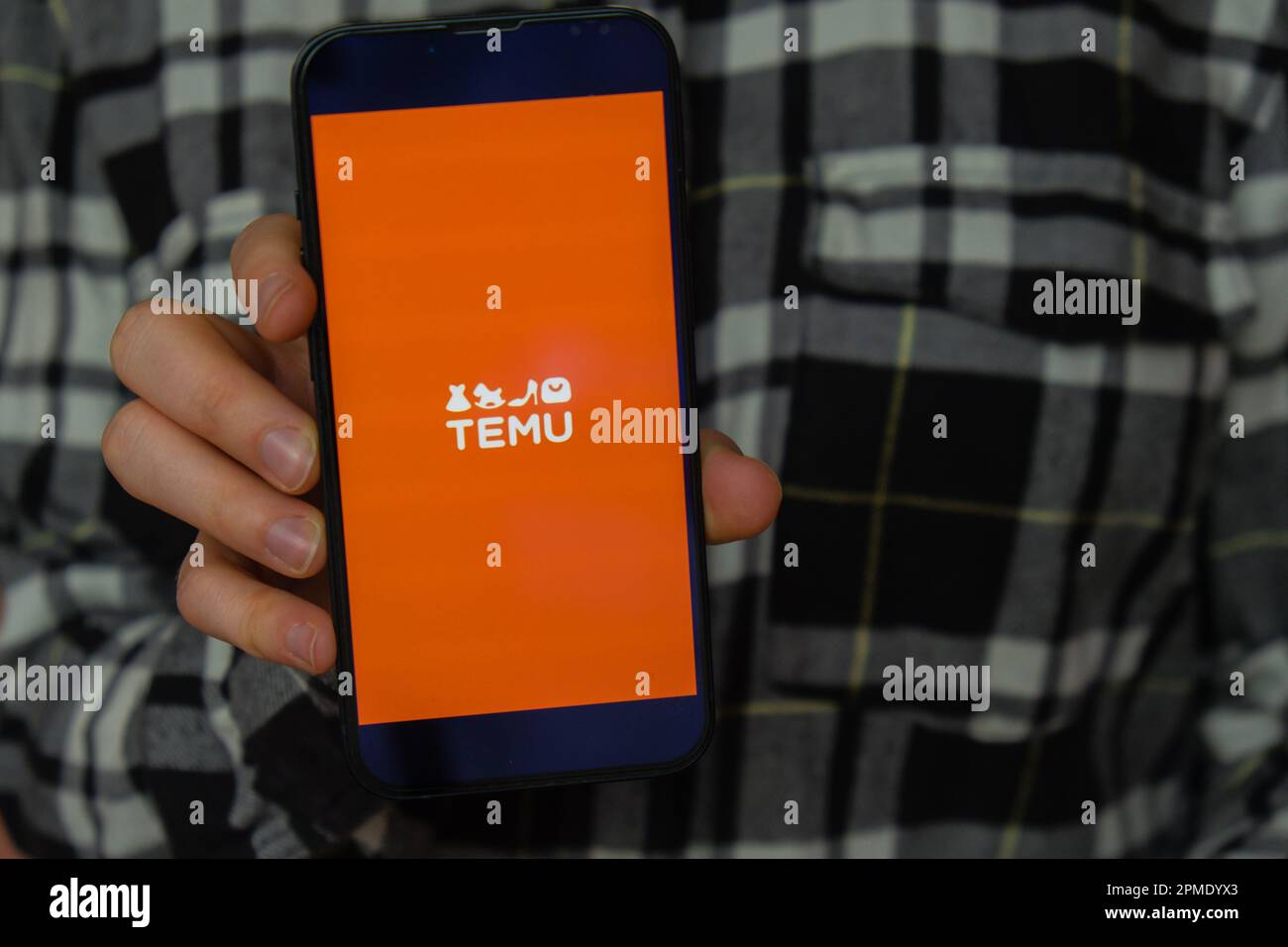 Gdansk, Poland - March 2023 Female hand holding Temu app icon in screen ...