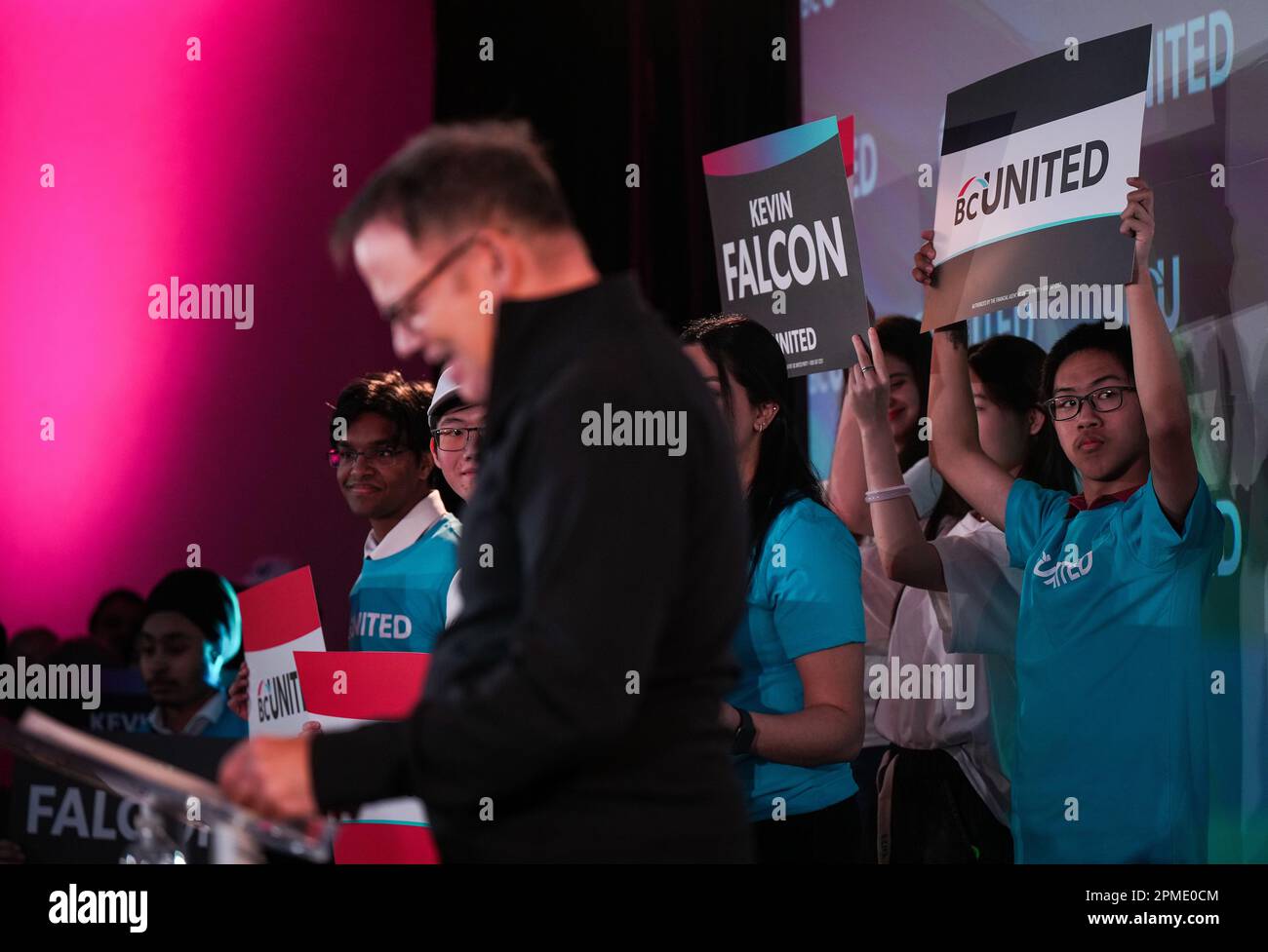Surrey, Canada. 12th Apr, 2023. Supporters hold signs while listening ...