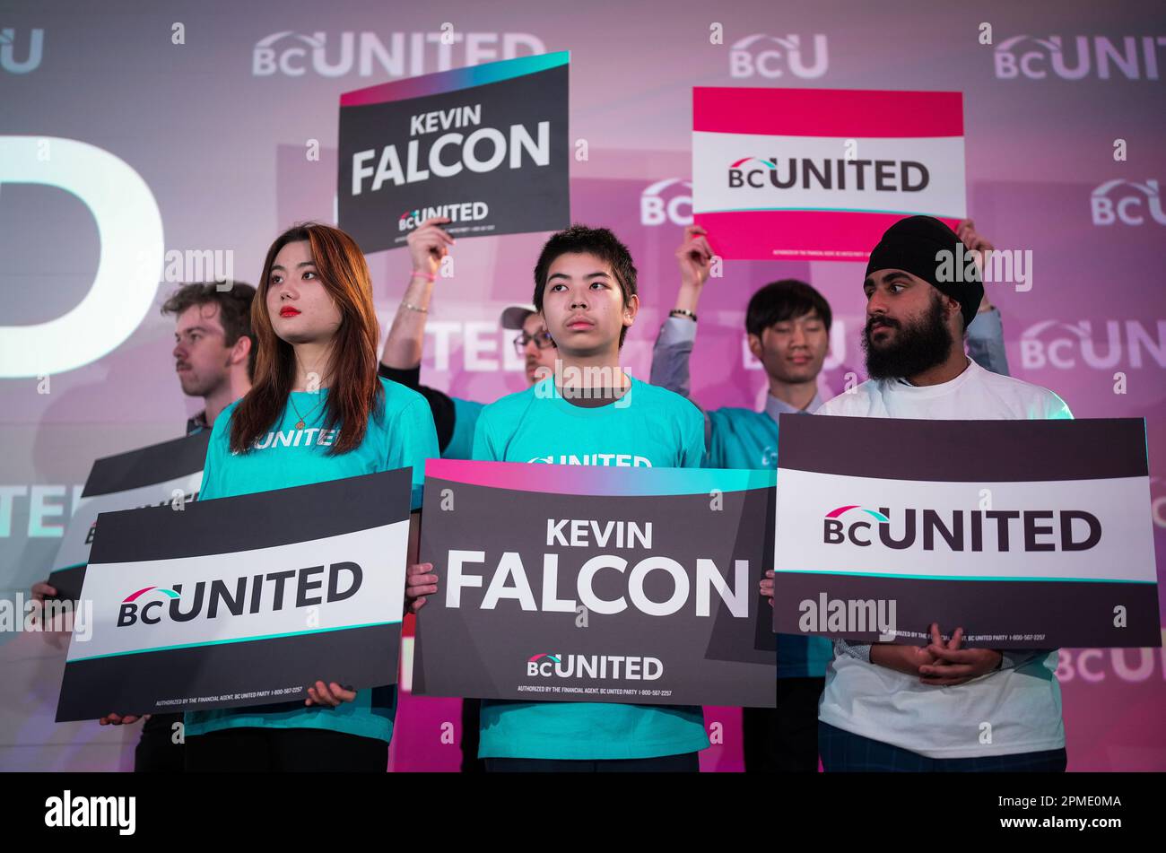 Surrey, Canada. 12th Apr, 2023. Supporters hold signs while listening ...