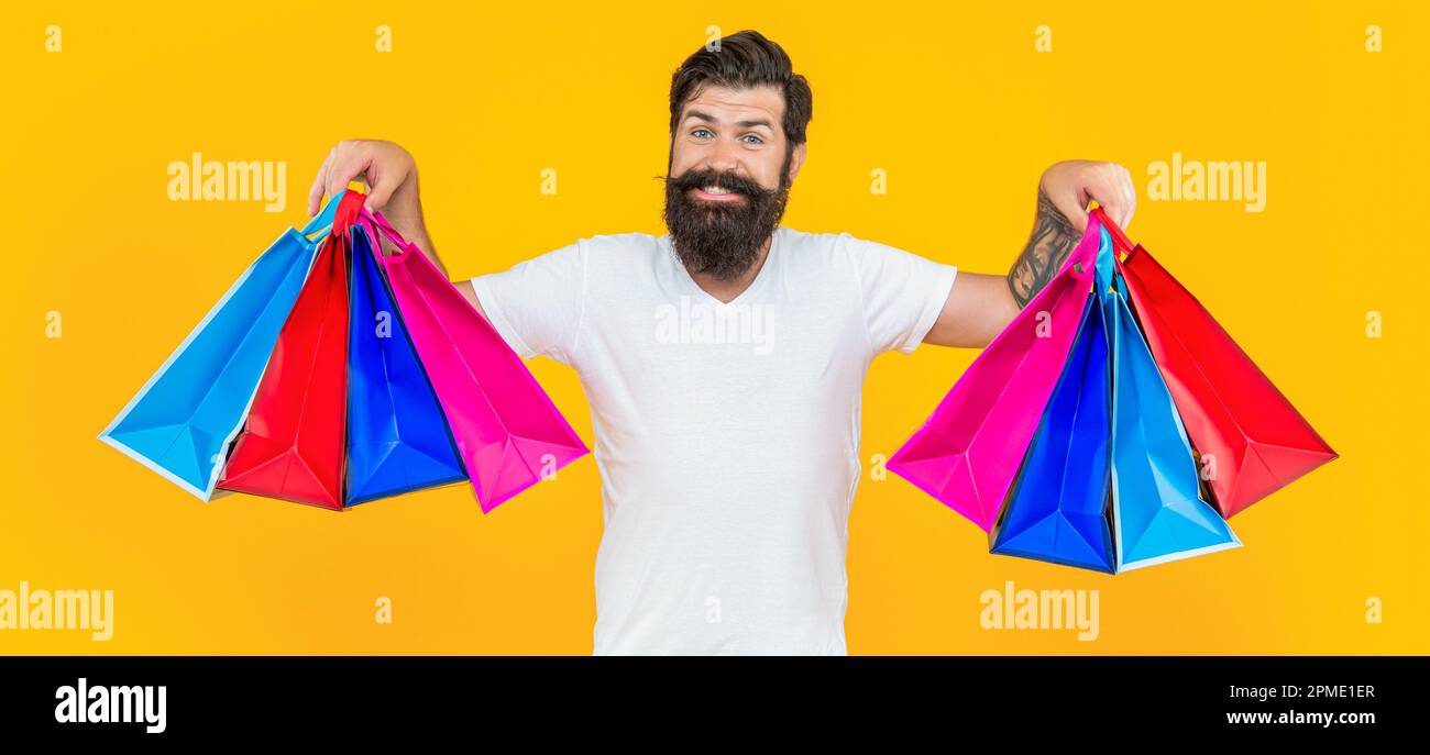 happy shopping man in studio. shopping man on background. photo of ...