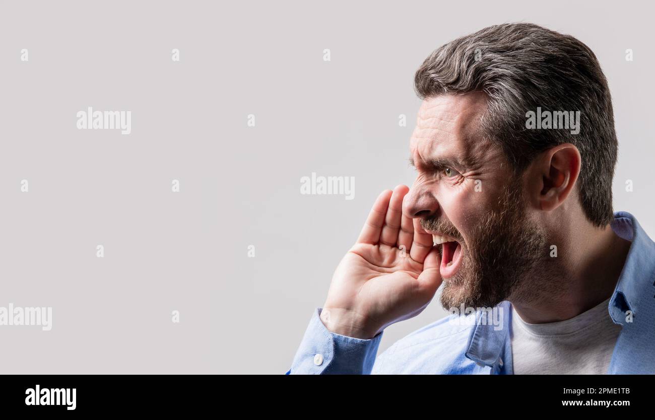 man with shouting face isolated on studio background, copy sace banner ...