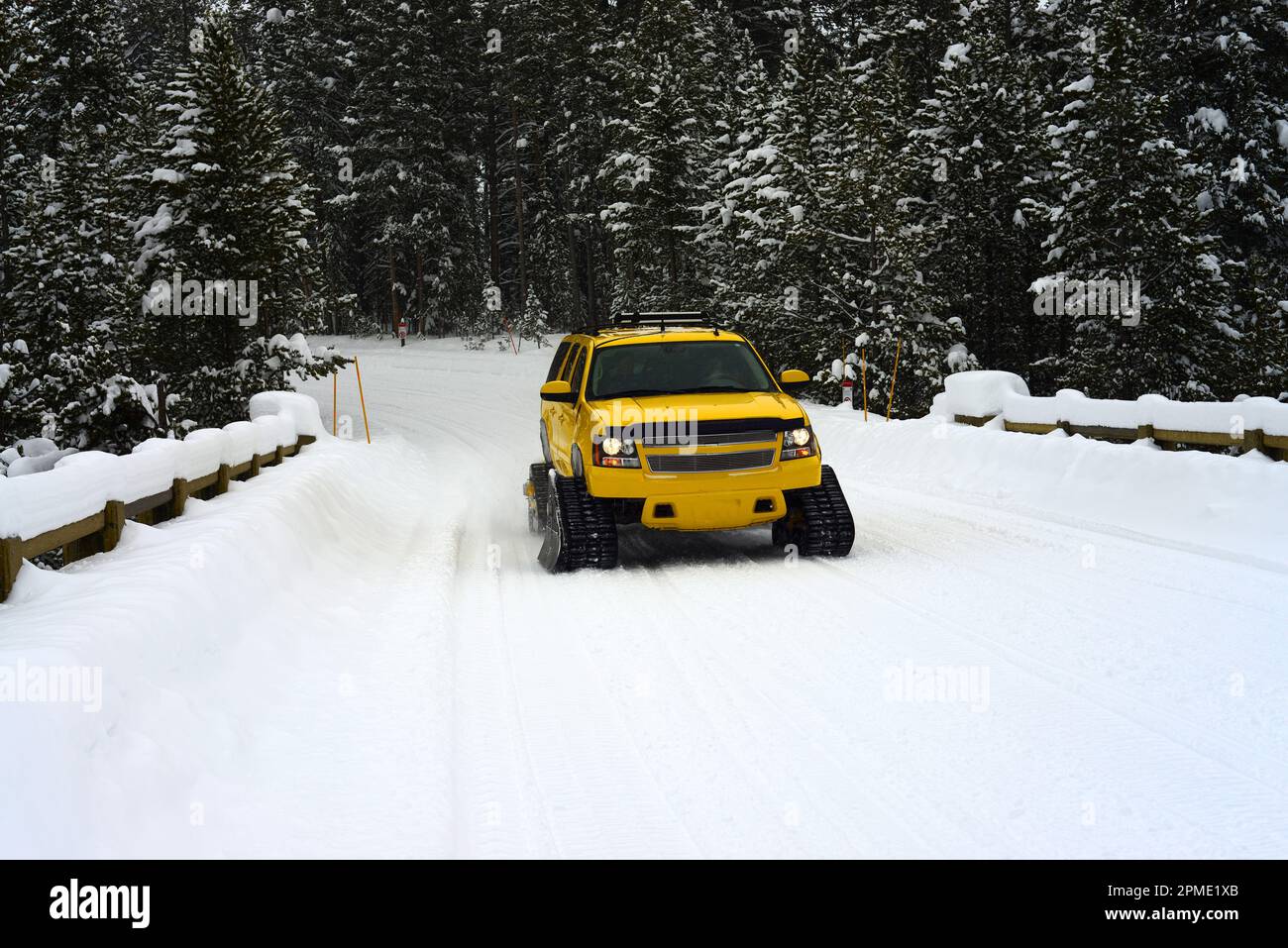 Track driven snowcoach driving on snow packed road Stock Photo - Alamy