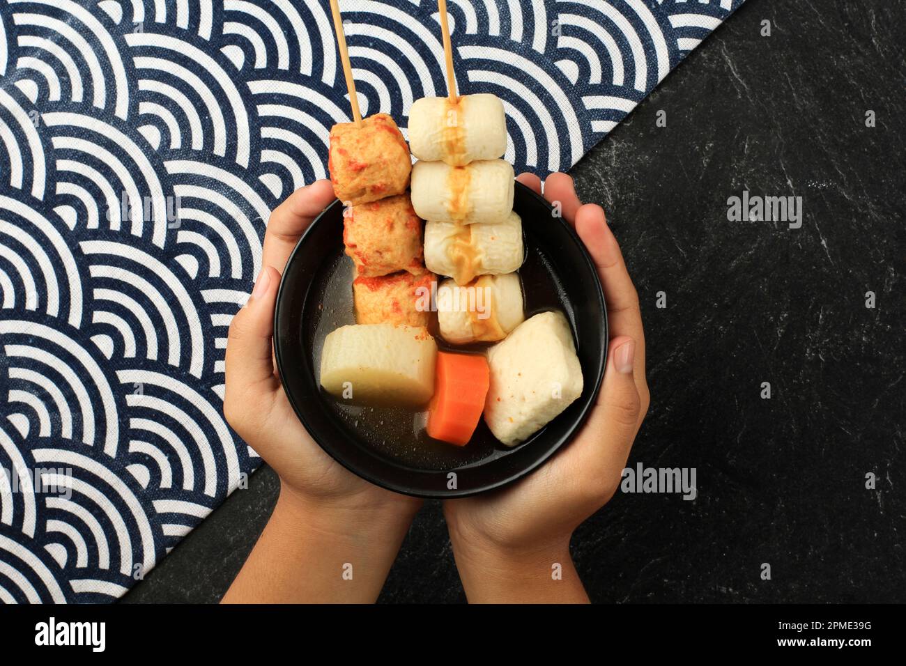 A Bowl of Japanese Oden Fish Ball Soup Skewer, Hold by Female Hand, Top ...