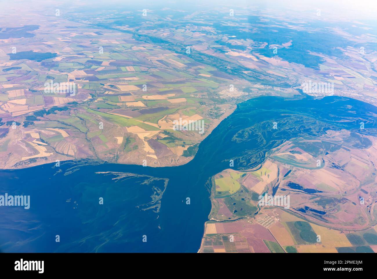 Aerial view from airplane window above green ground. View from the ...