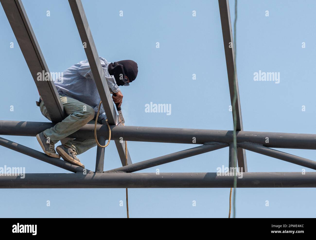 Welder welding roof structure on new building in factory Stock Photo ...