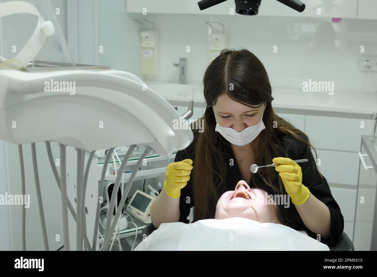 Dentist in yellow gloves black hi-res stock photography and images - Alamy