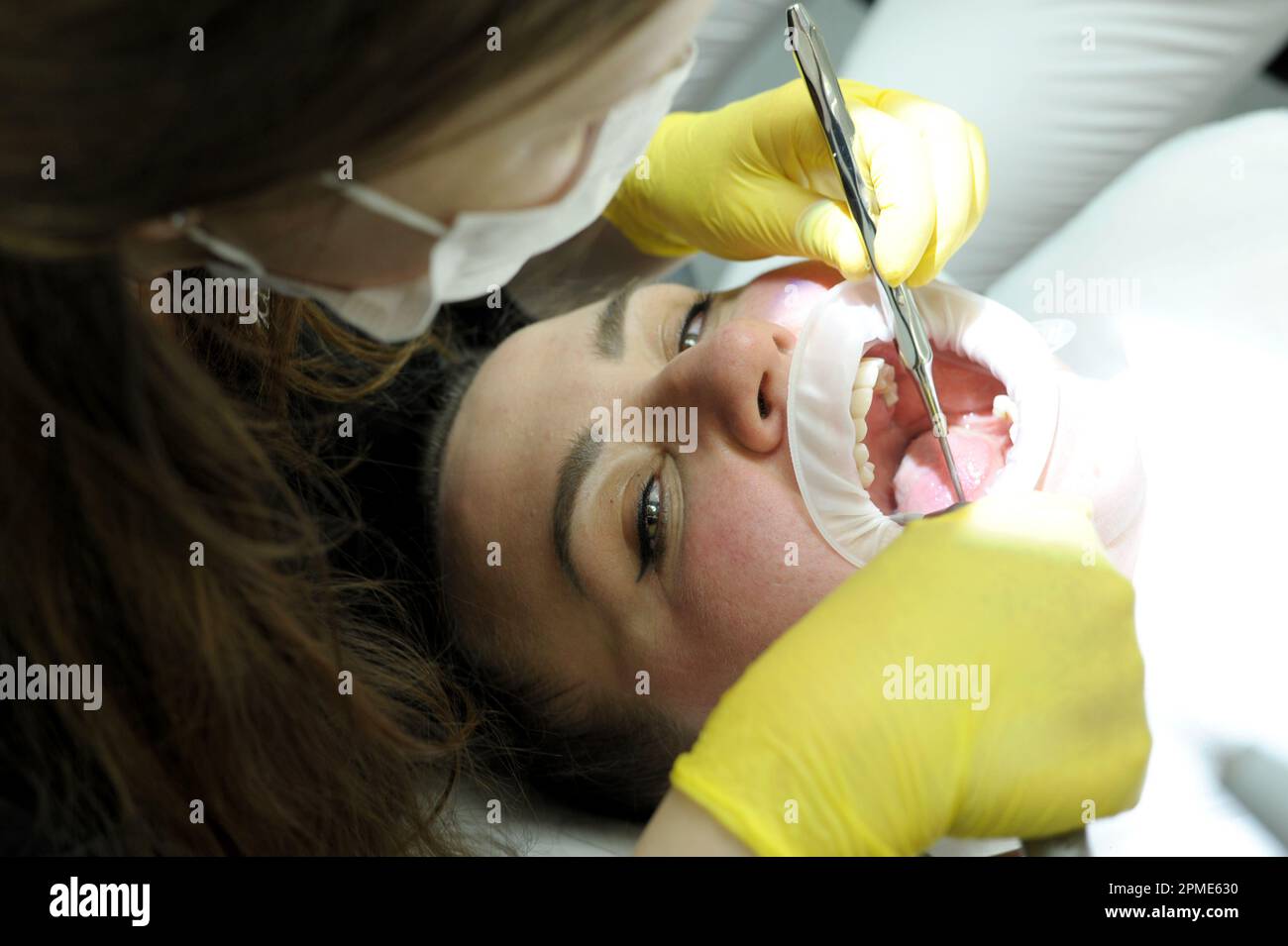 Dentist in yellow gloves black hi-res stock photography and images - Alamy
