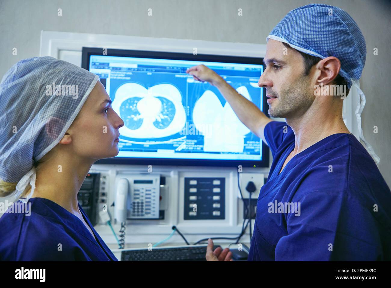 We can still save this patient. a team of surgeons discussing a ...