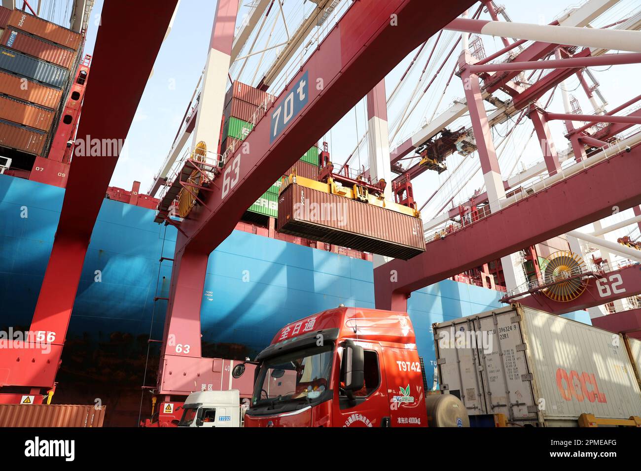 QINGDAO, CHINA - APRIL 13, 2023 - Container trucks load cargo at the ...