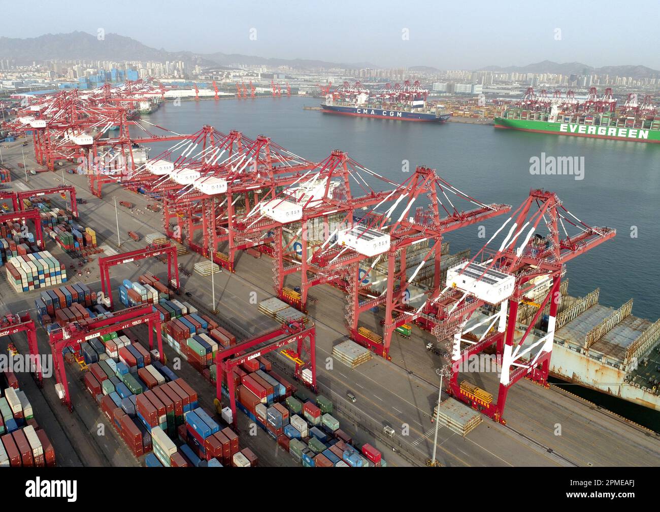 QINGDAO, CHINA - APRIL 13, 2023 - Dozens of cargo ships load and unload ...