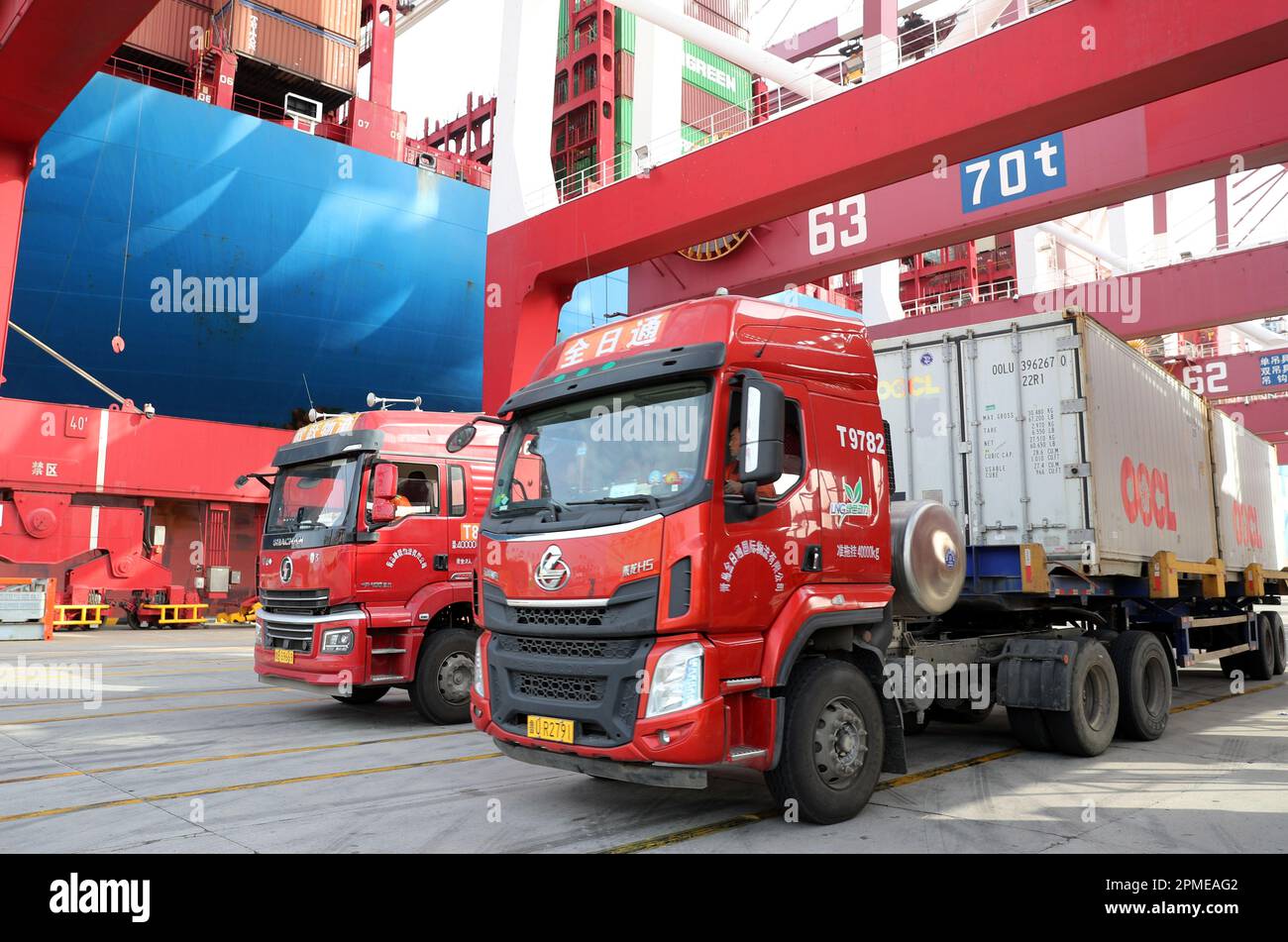 QINGDAO, CHINA - APRIL 13, 2023 - Container trucks load cargo at the ...