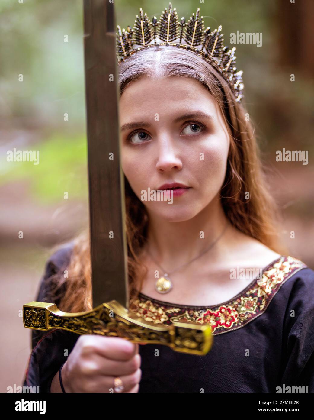 Young Woman in Fairytale Queen Costume with Crown Wielding Large ...
