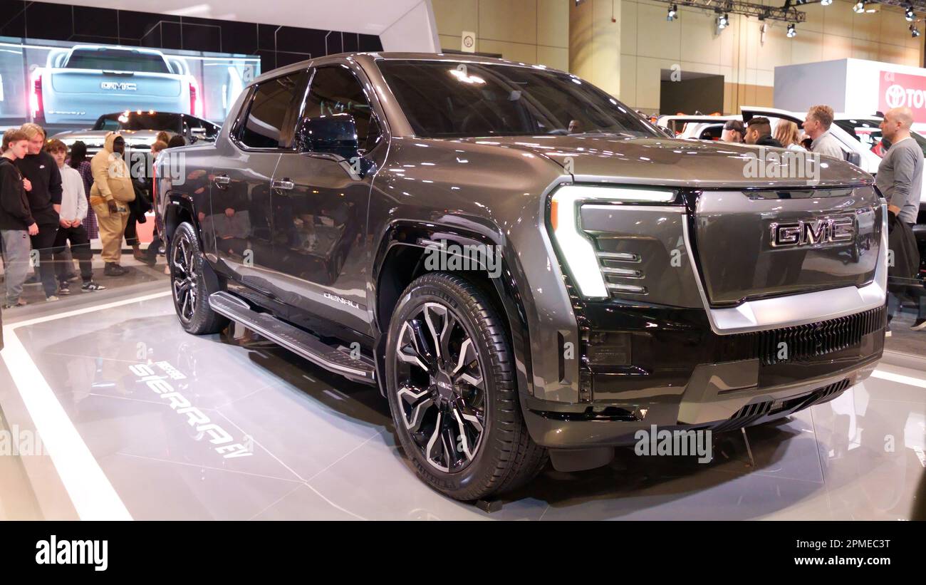 Crowds looking at new car models at Auto show. GMC car on display ...
