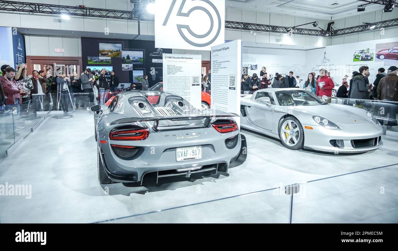 Crowds looking at new car models at Auto show. Porsche Spyder car on ...
