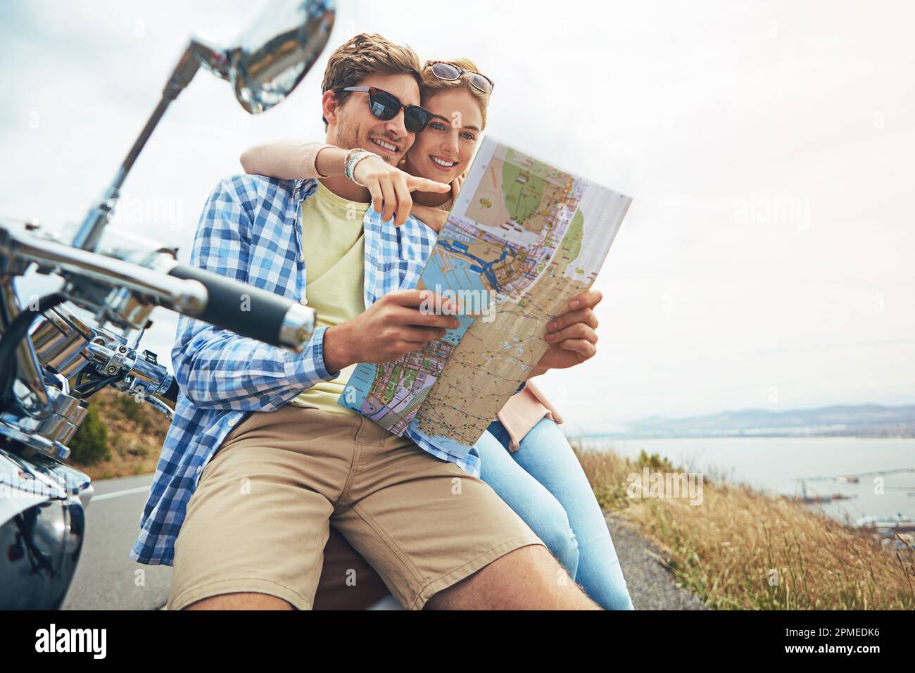 Wheres our next stop. a couple using a map while out on a road trip ...