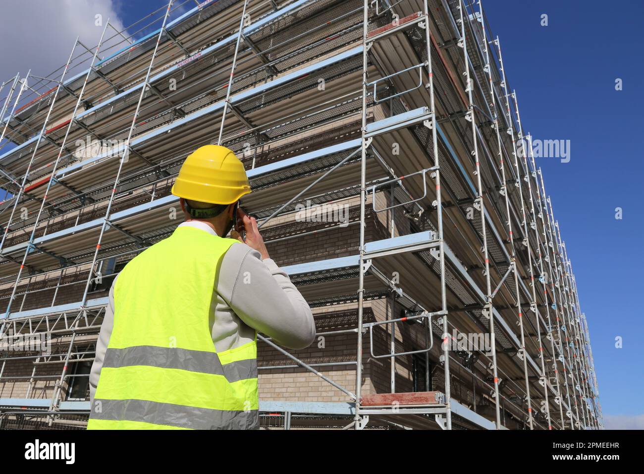 Symbol image: Architect in front of an apartment building under ...