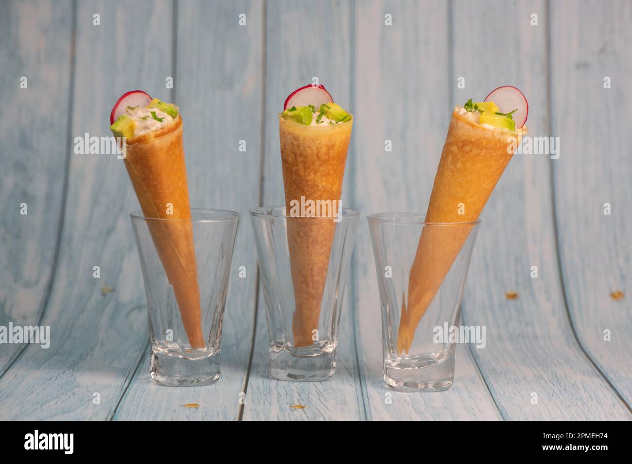 Brick cone with tuna sauce, mayonnaise, avocado and radish slice Stock ...