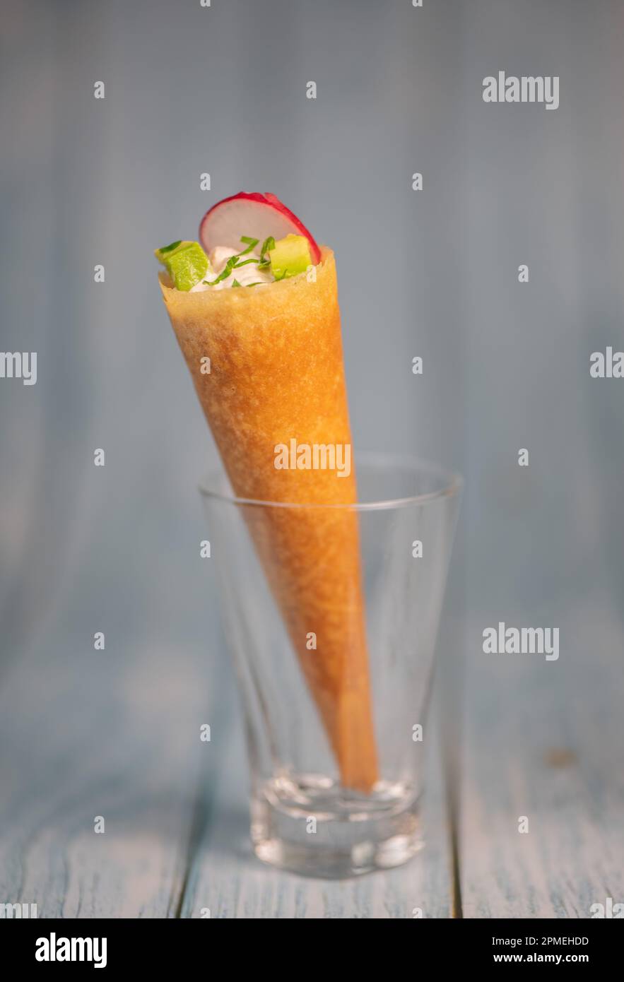 Brick cone with tuna sauce, mayonnaise, avocado and radish slice Stock ...