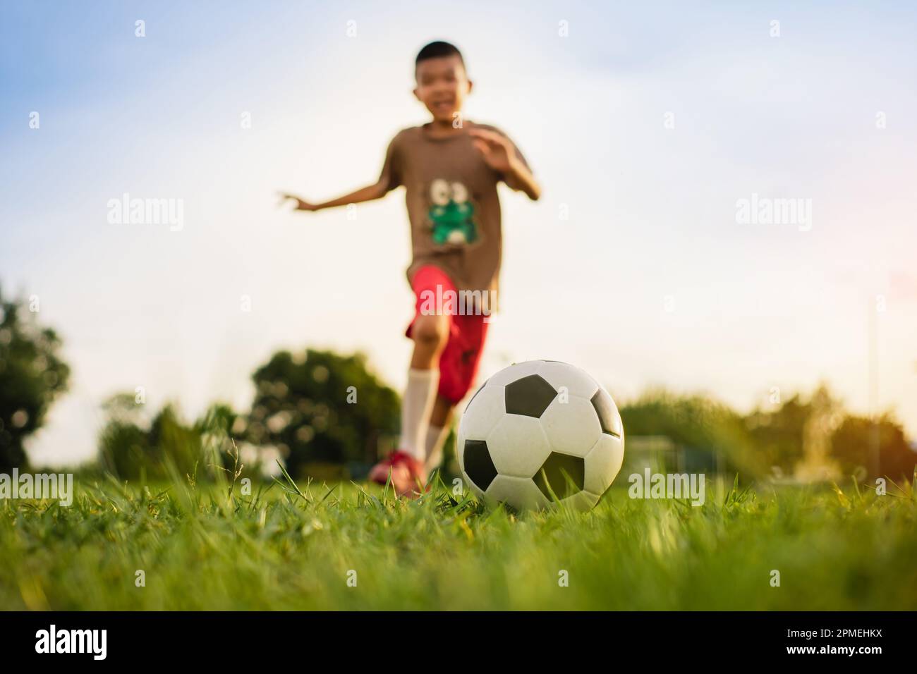 action sport outdoors of a group of kids having fun playing soccer ...