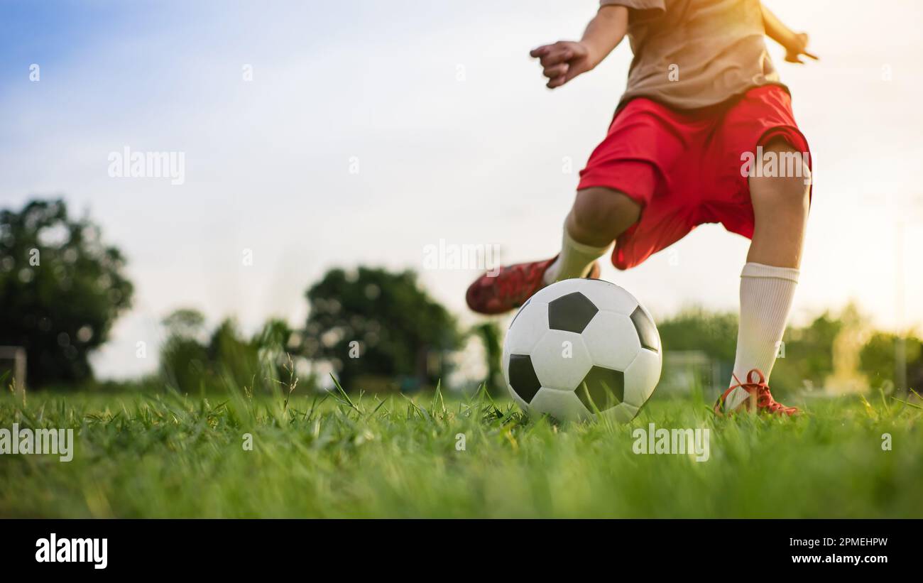 action sport outdoors of a group of kids having fun playing soccer ...