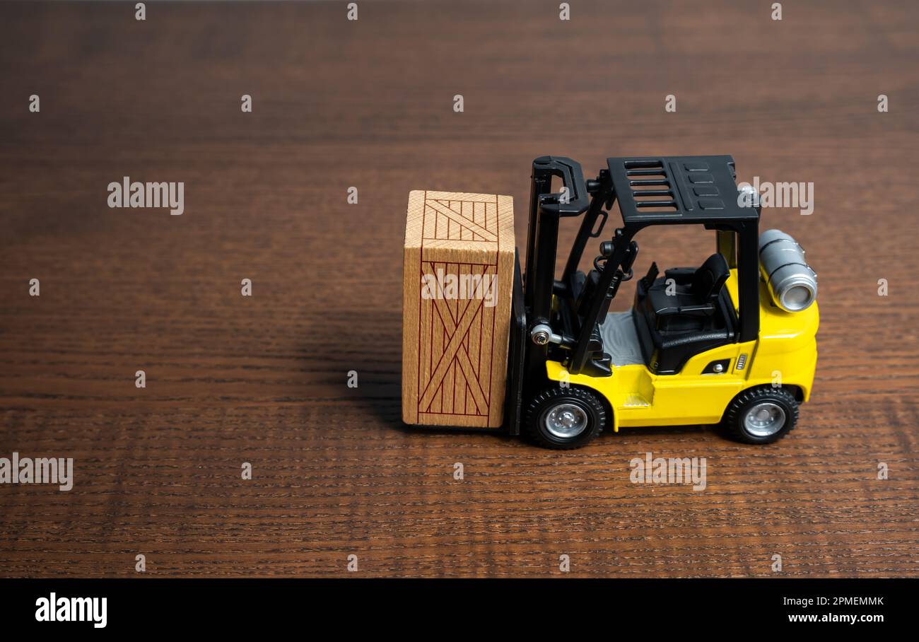 A forklift truck transports a wooden crate box. Trading transportation ...