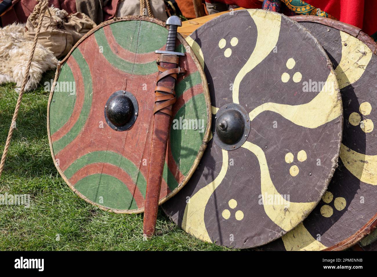 Medieval weapons, shields in knight camp at the festival of historical ...