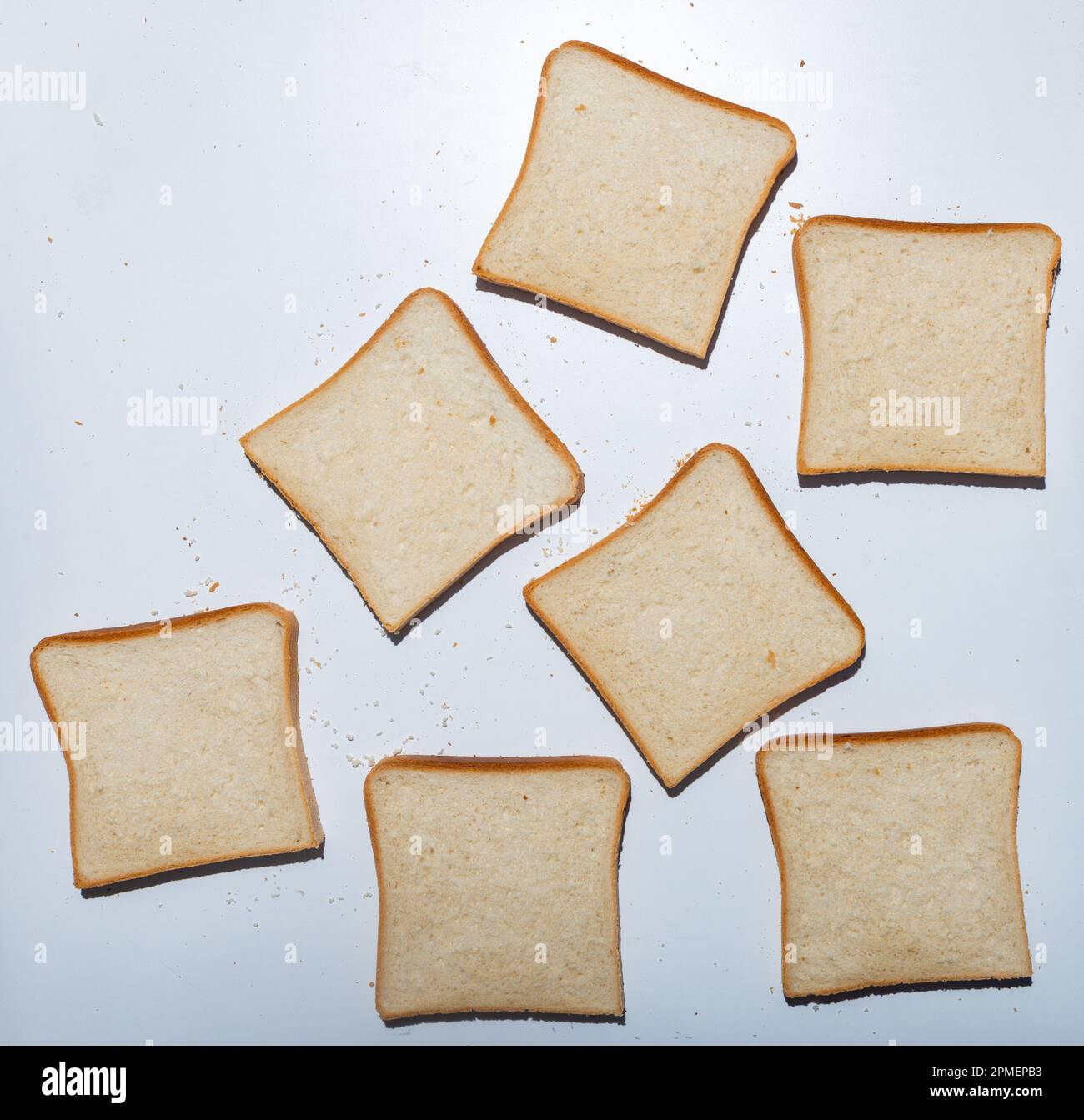 Top view of white toast bread slices with crumbs on isolated white ...