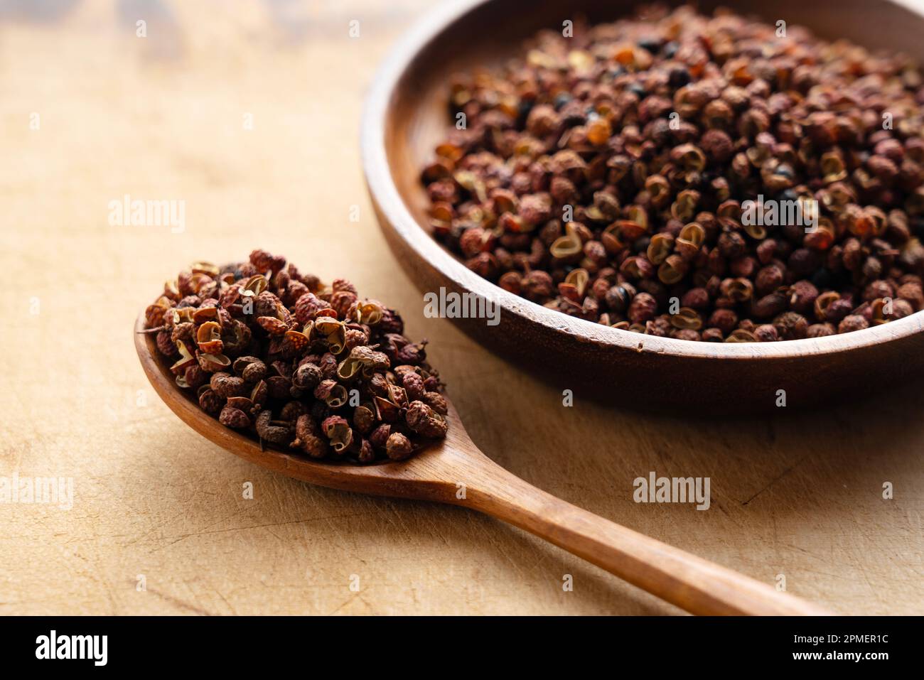 Sichuan pepper and wooden spoon on the table. Sichuan pepper is a ...