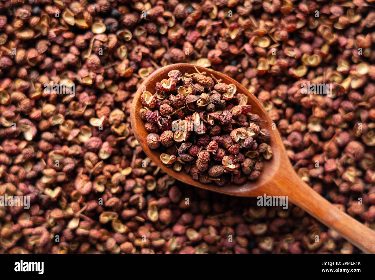 Sichuan pepper and wooden spoons placed throughout the screen. Sichuan ...