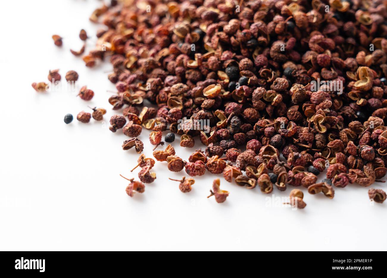 Sichuan pepper placed on a white background. Sichuan pepper is a member ...