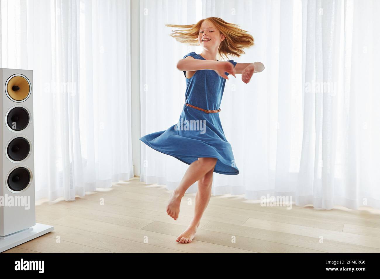 She loves to dance. Full length shot of a little girl dancing at home ...