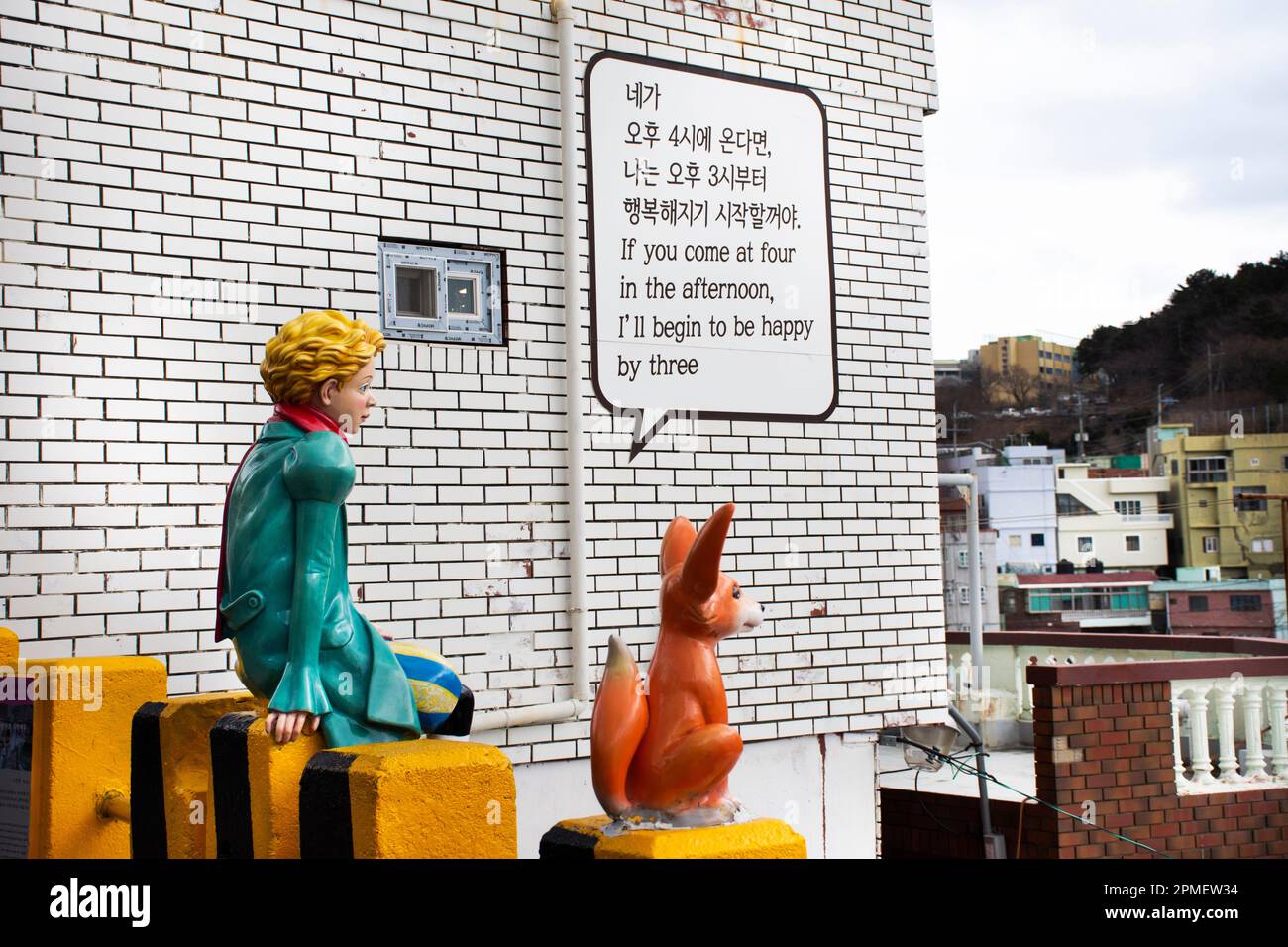 Little prince figure and fox statue with landscape cityscape of ...