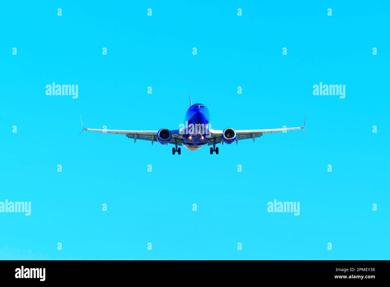 Airplane descending for landing with clear view of the underbelly and ...