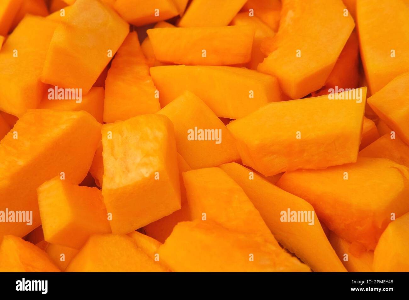 Slices of fresh pumpkin chunks background. Yellow Juicy pieces of ...